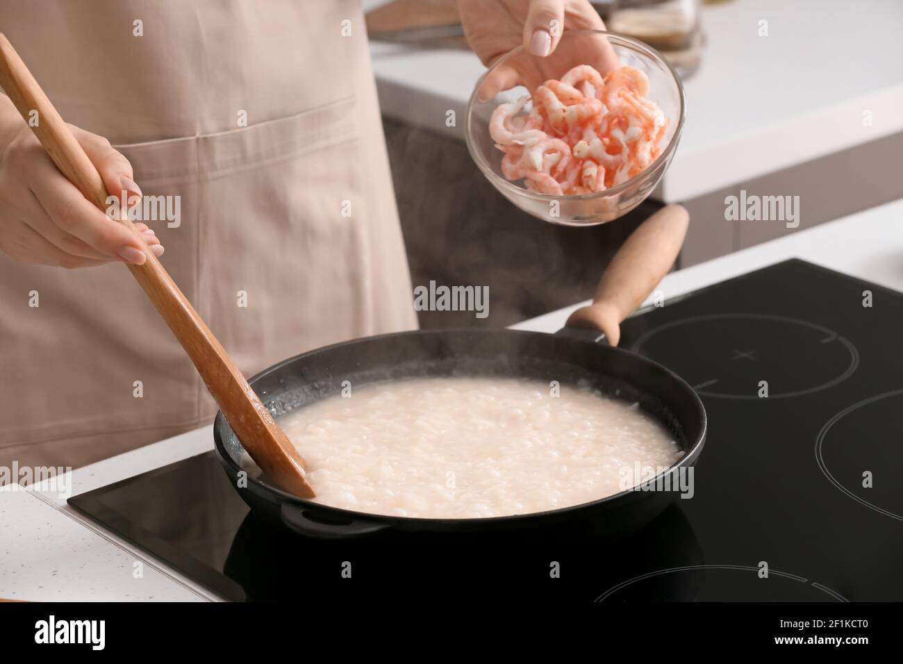 Woman hands cooking adding rice hi-res stock photography and images - Alamy