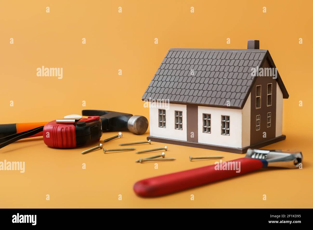 Model of house with construction tools on color background Stock Photo ...