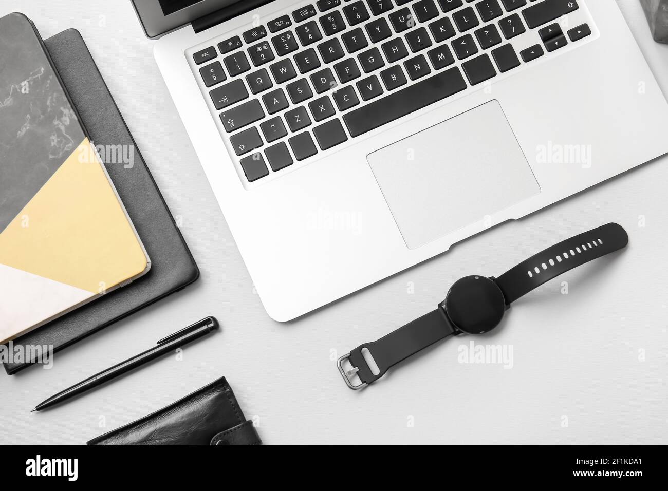 Modern smart watch, laptop and notebooks on light background Stock ...