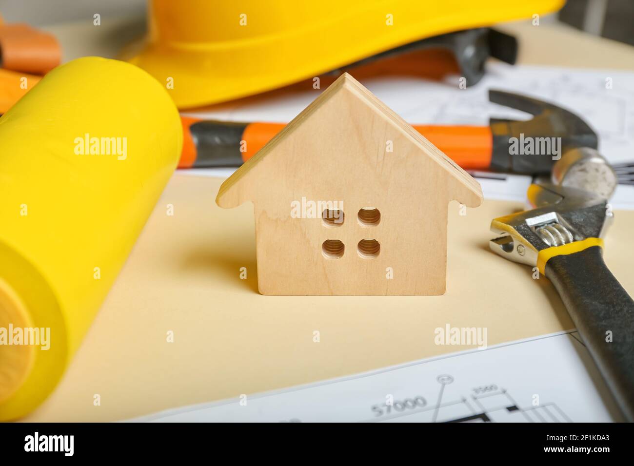 Figure of house with builder's supplies on table, closeup Stock Photo ...