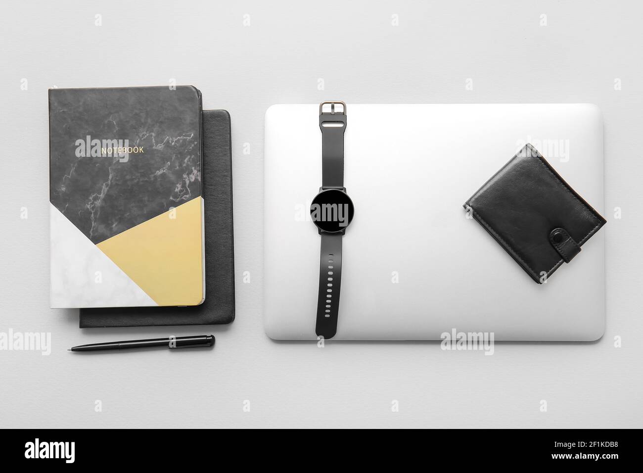 Modern smart watch, laptop and notebooks on light background Stock ...