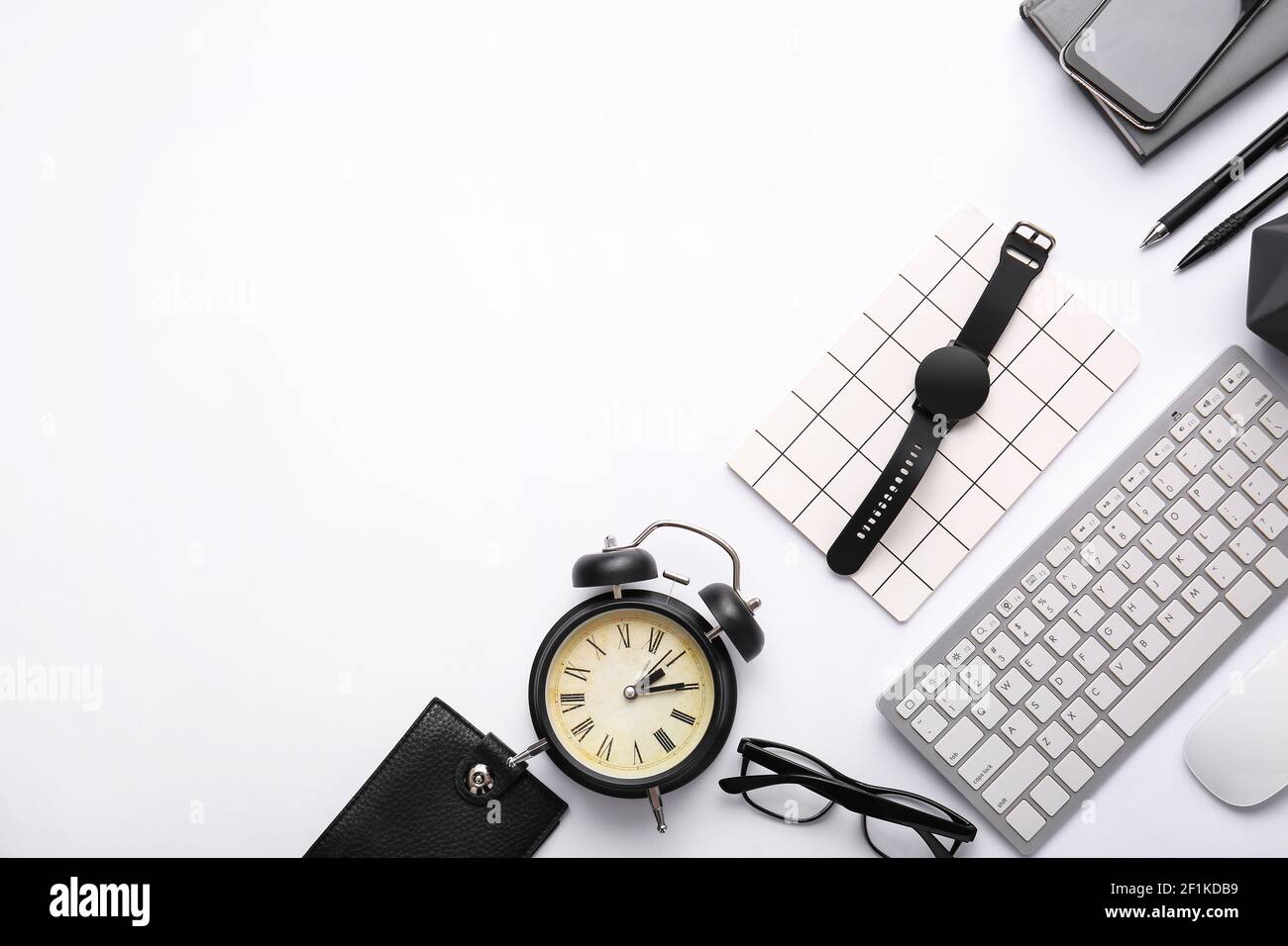 Composition with modern smart watch, computer keyboard and alarm clock ...