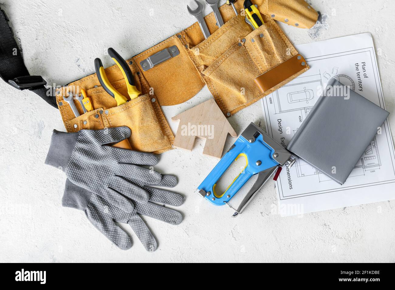 Figure of house and construction tools on light background Stock Photo ...