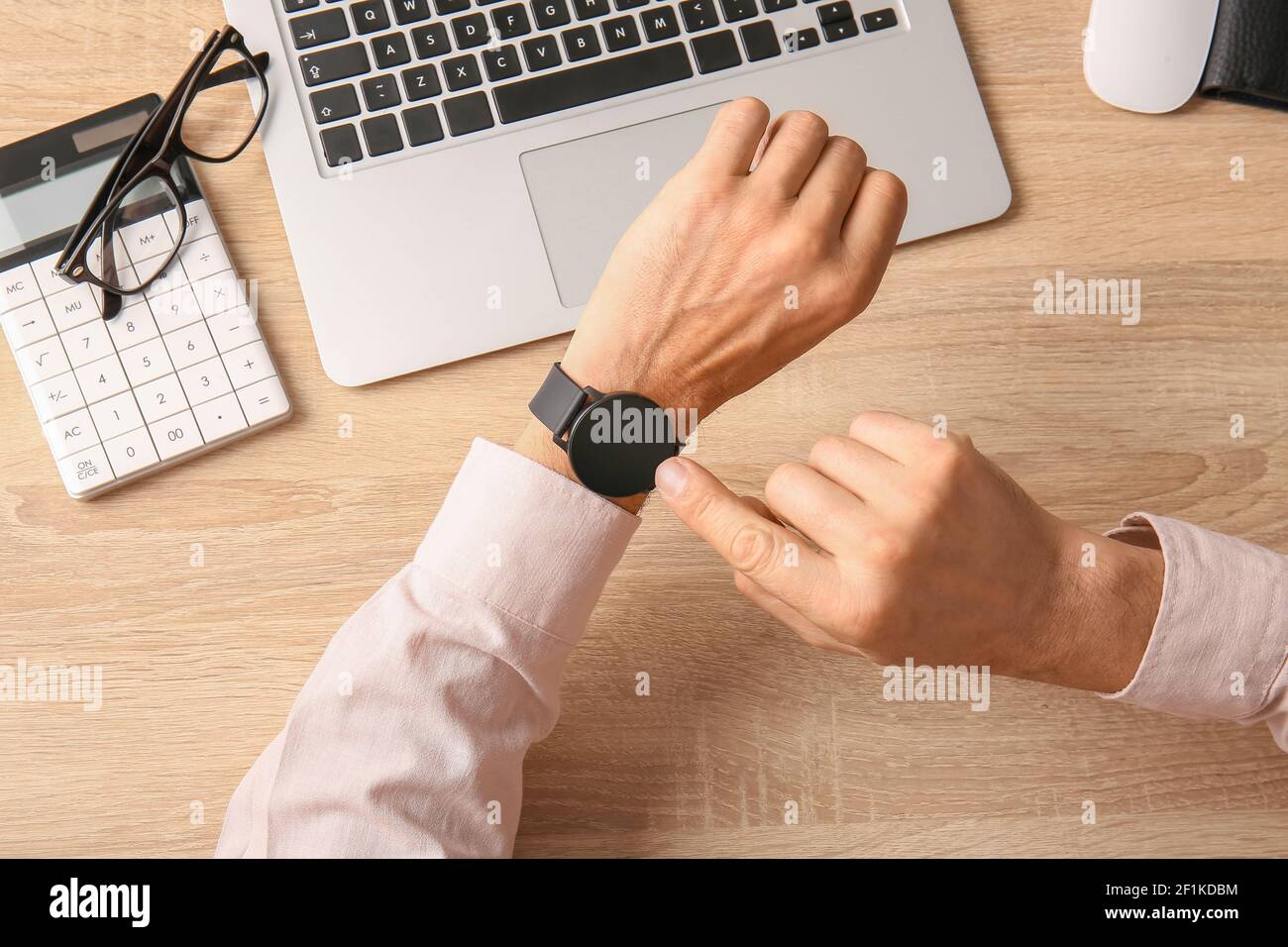 Man with modern smart watch in office Stock Photo - Alamy
