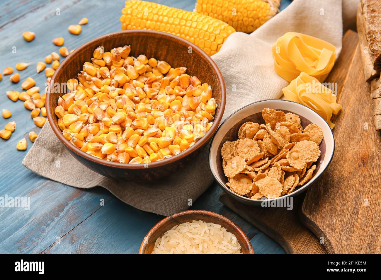 Different cereals and raw pasta on color wooden background, closeup ...