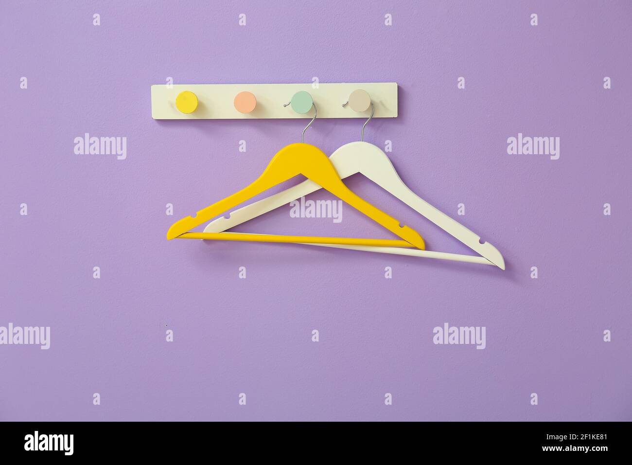 Different hangers on color background Stock Photo - Alamy