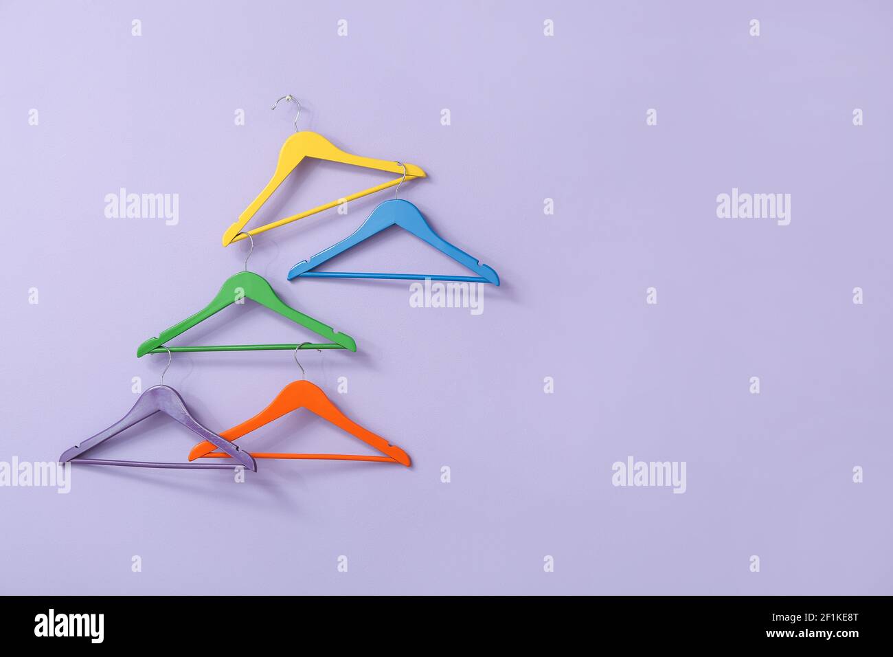 Different hangers on color background Stock Photo - Alamy