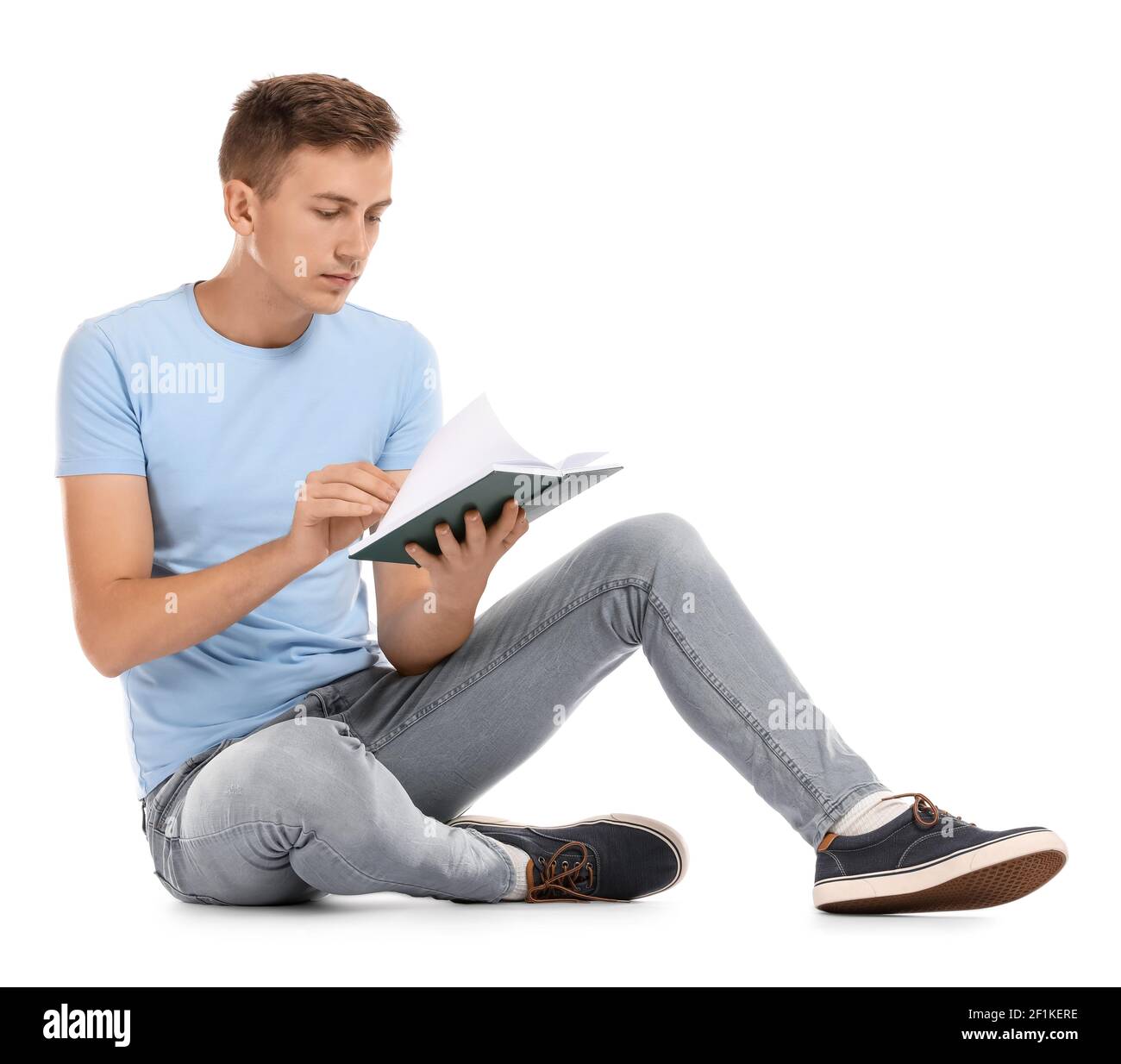 Young man reading book on white background Stock Photo - Alamy