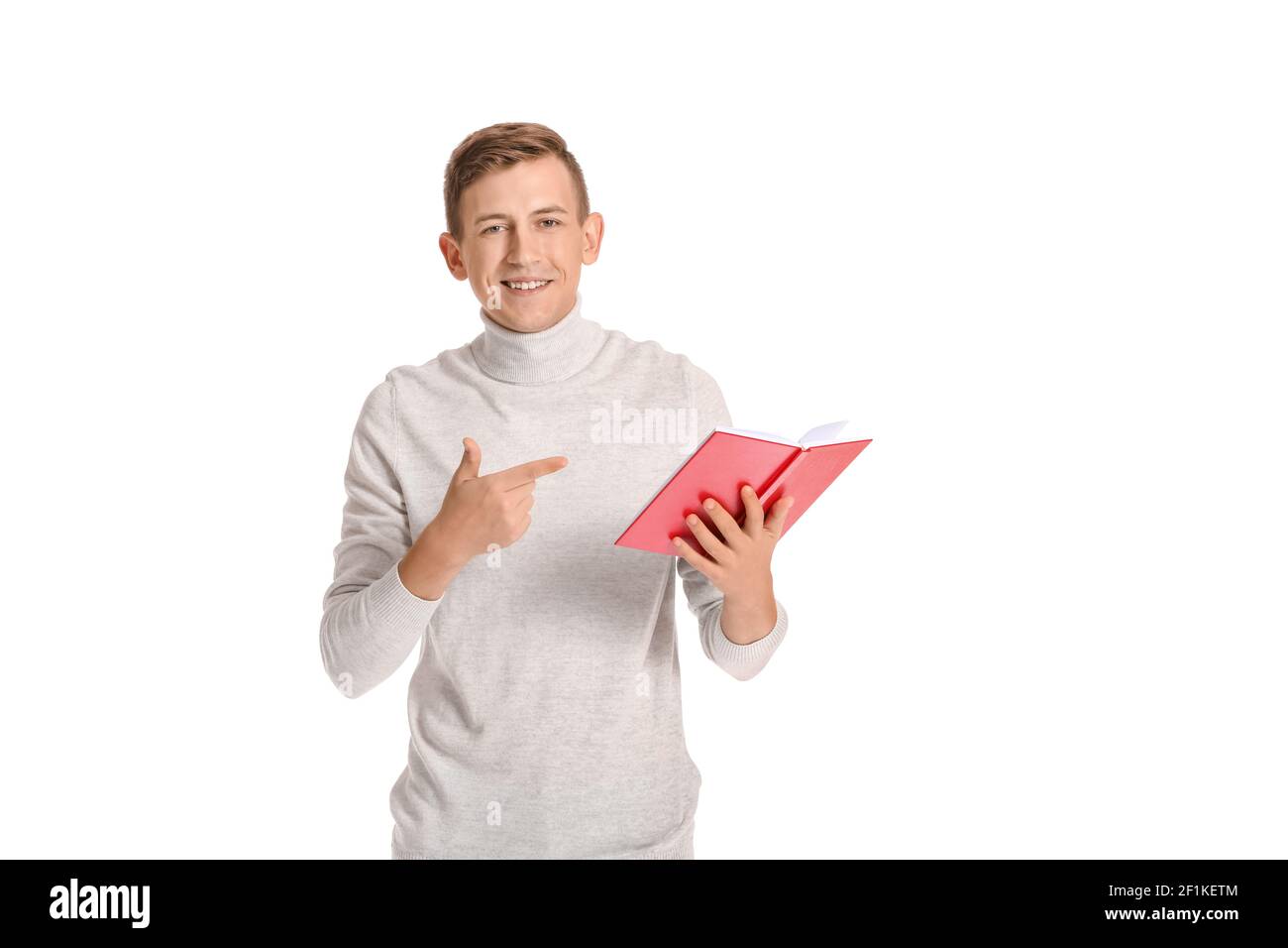 Young man with red book on white background Stock Photo - Alamy