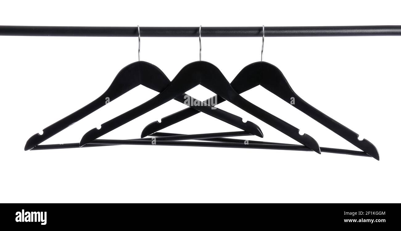 Clothes hangers on rack against white background Stock Photo - Alamy
