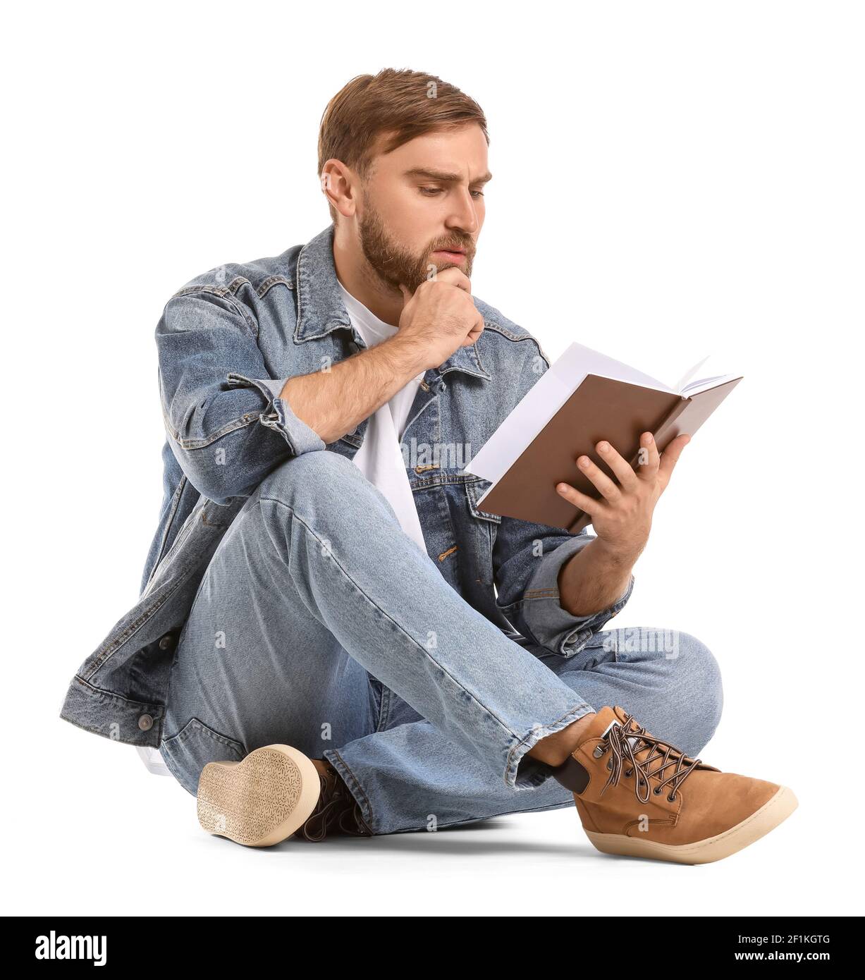 Young man reading book on white background Stock Photo - Alamy