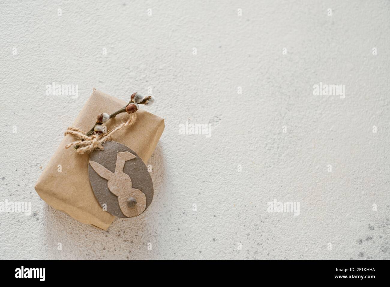 Gift box wrapped in kraft paper tied with willow branch, twine ...
