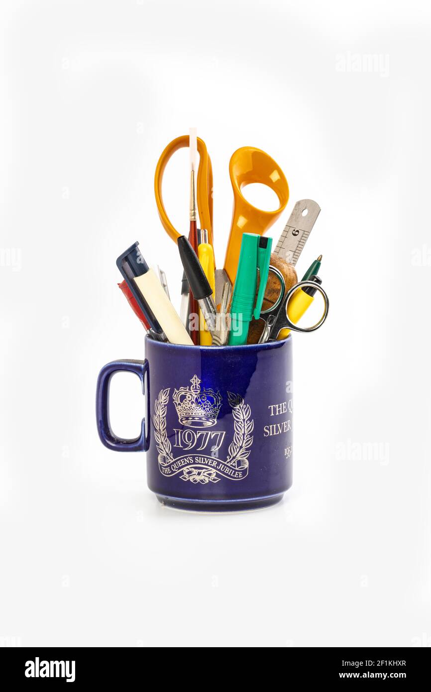 A mug filled with pens and artists materials Stock Photo - Alamy
