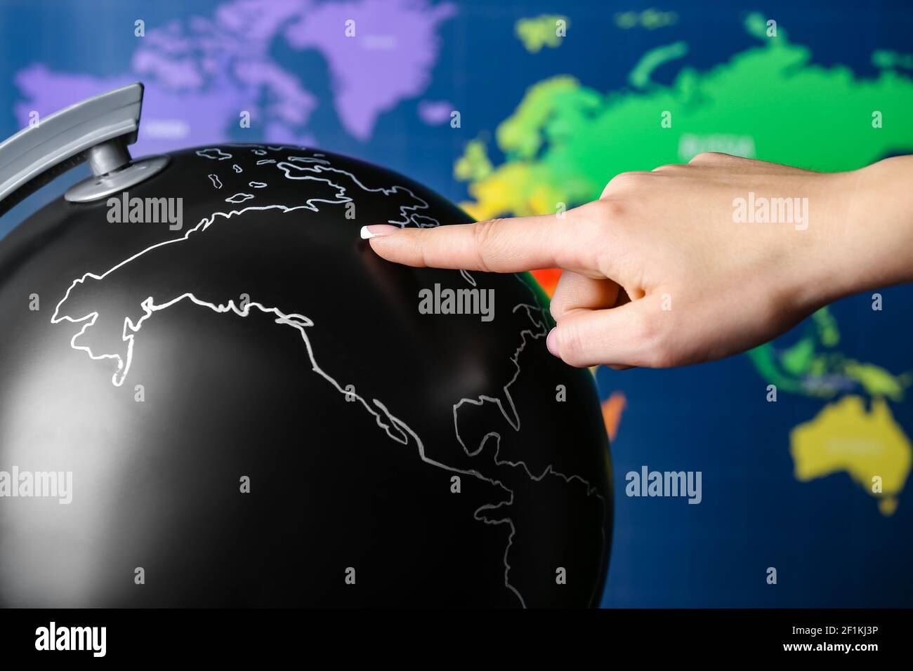 Female hand with globe on world map background, closeup Stock Photo - Alamy