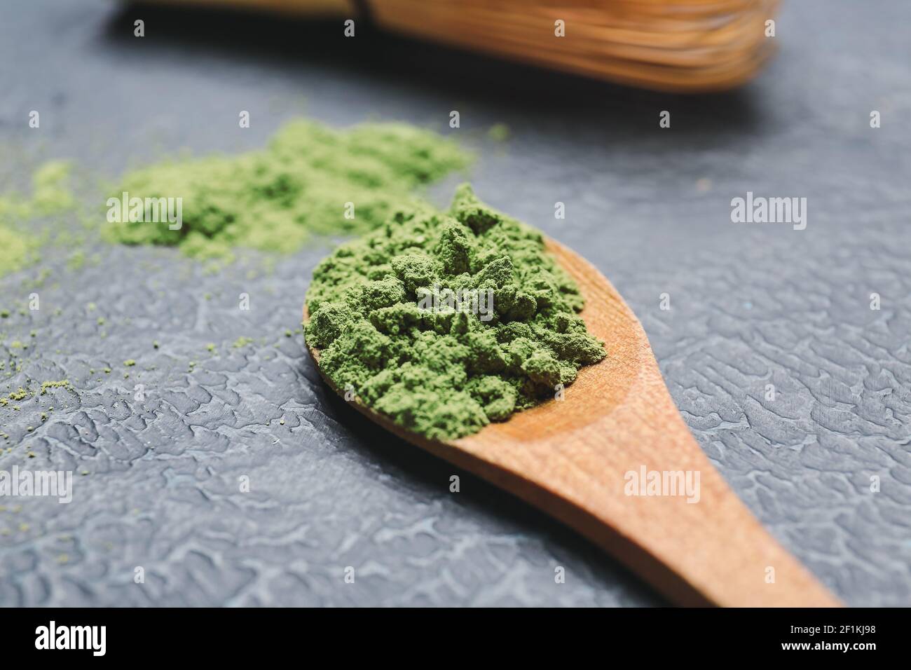 Spoon with powdered matcha tea on dark background Stock Photo - Alamy