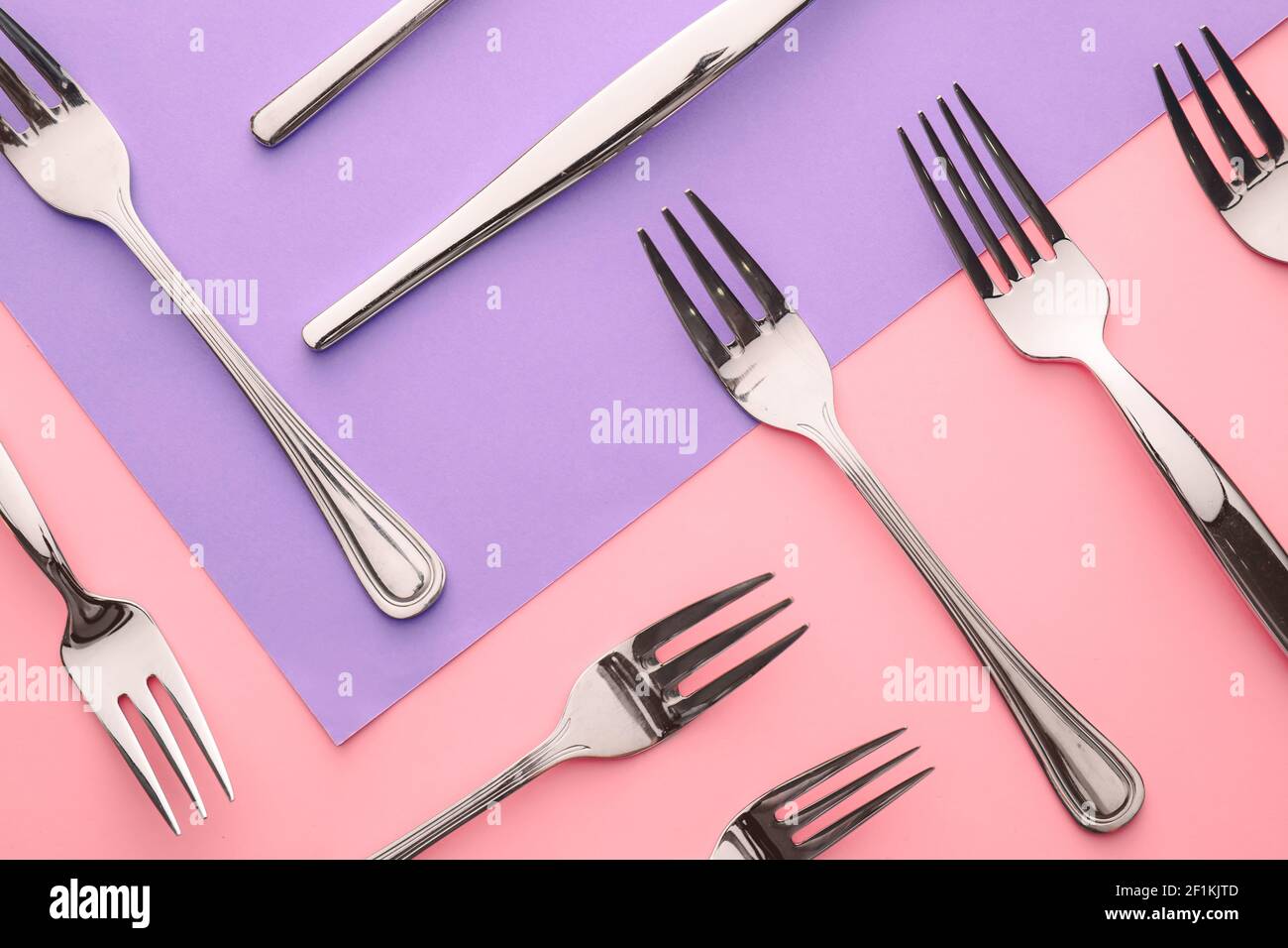 Stylish forks on color background Stock Photo - Alamy