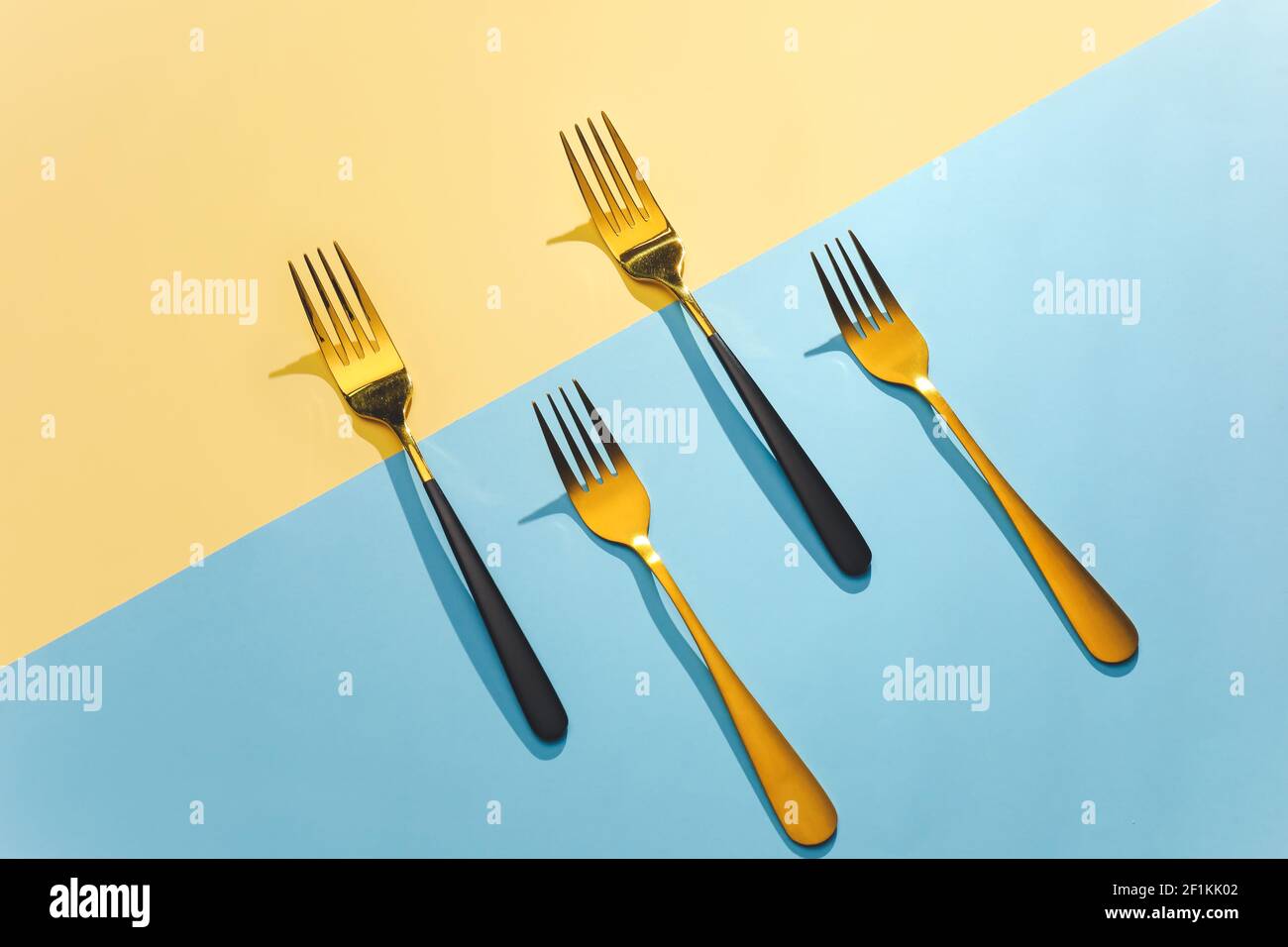 Stylish forks on color background Stock Photo - Alamy