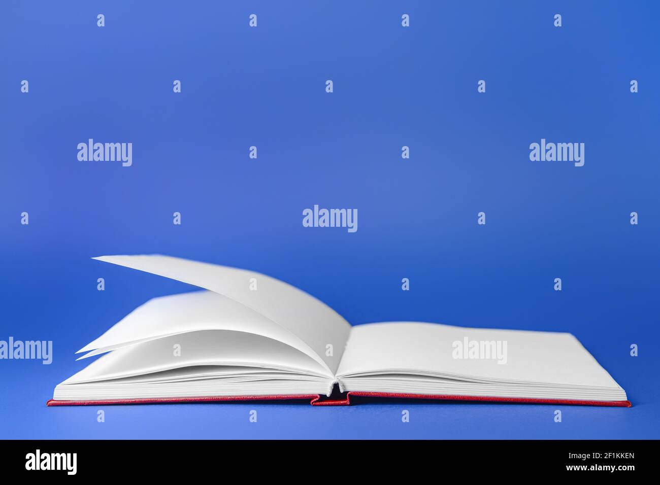 Blank open book on color background Stock Photo - Alamy