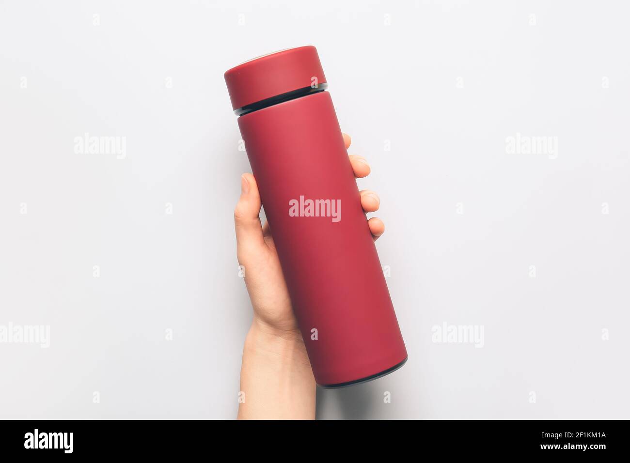 Female hand with modern thermos on light background Stock Photo - Alamy