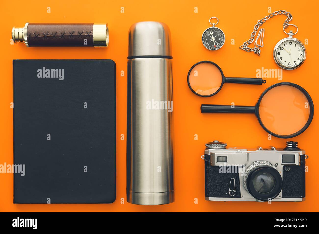 Modern thermos and items for travel on color background Stock Photo - Alamy