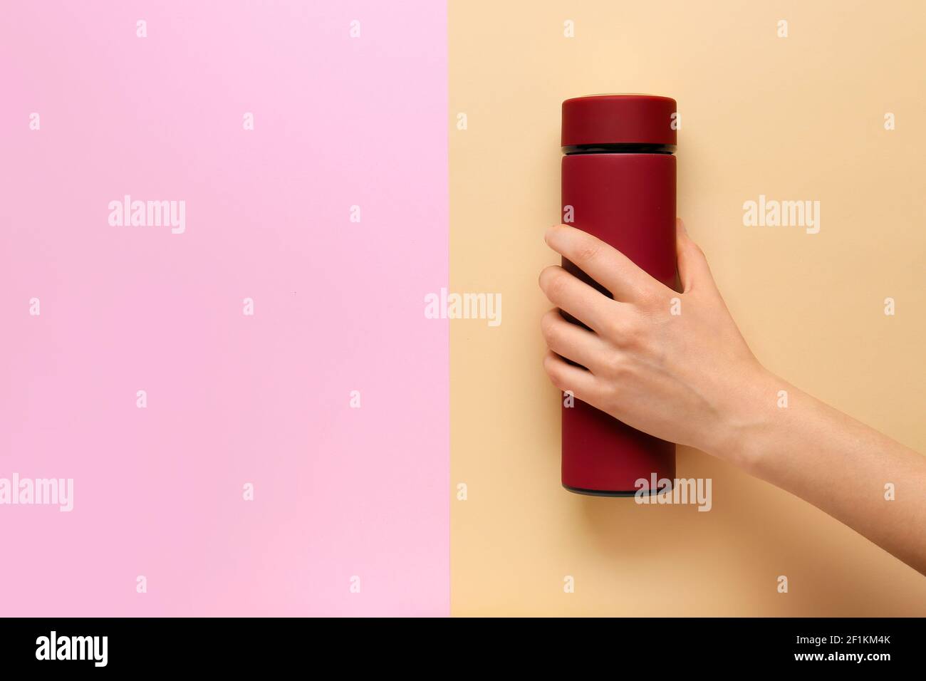 Female hand with modern thermos on color background Stock Photo - Alamy