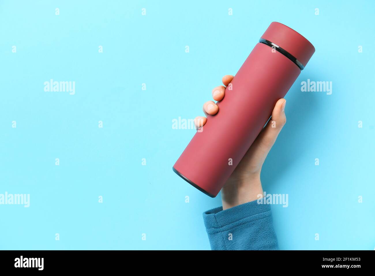 Female hand with modern thermos on color background Stock Photo - Alamy