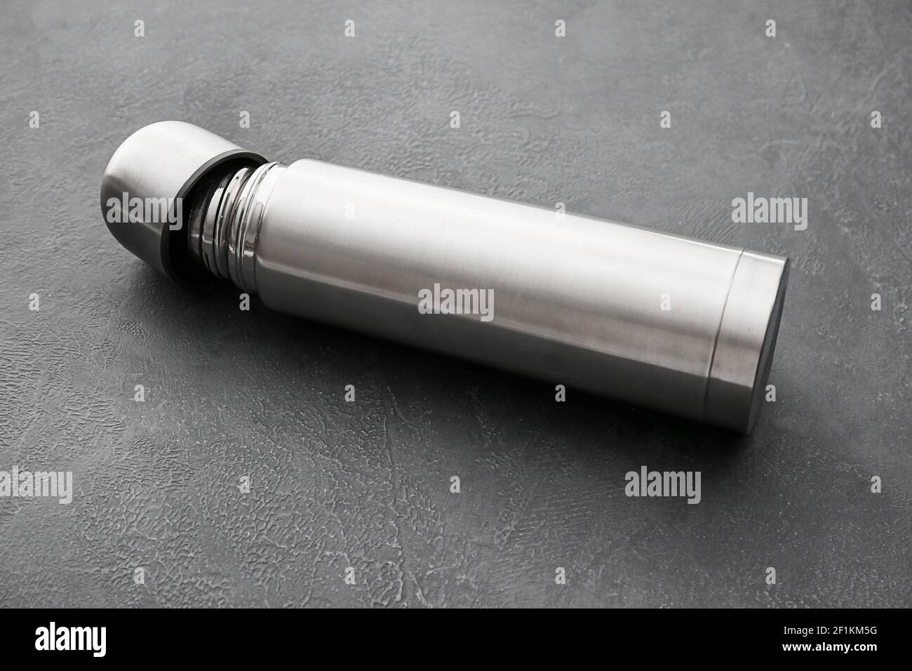 Modern thermos on dark background Stock Photo - Alamy