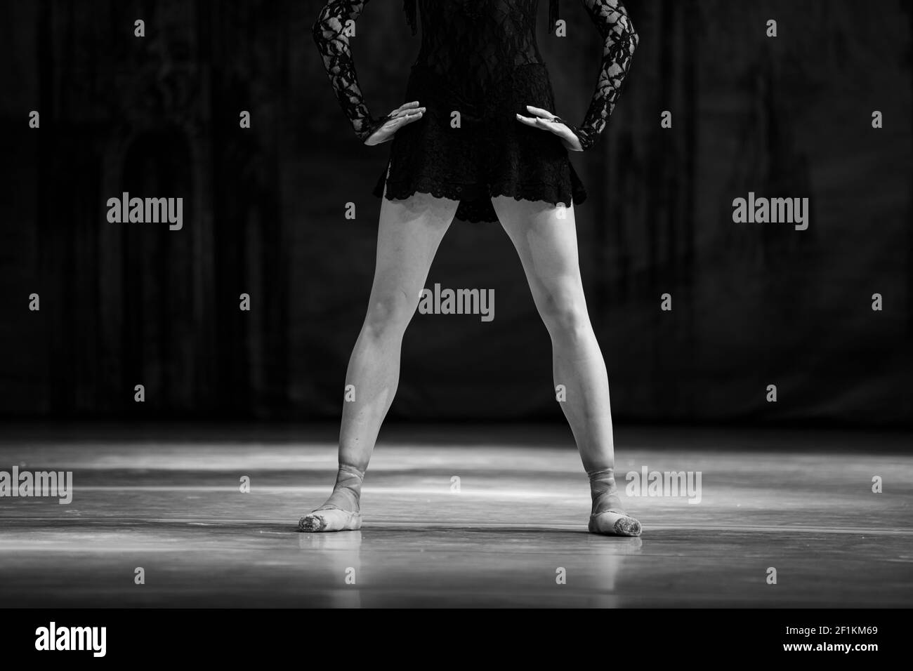 Closeup of ballerina dancing isolated on stage. Ballerina legs closeup ...