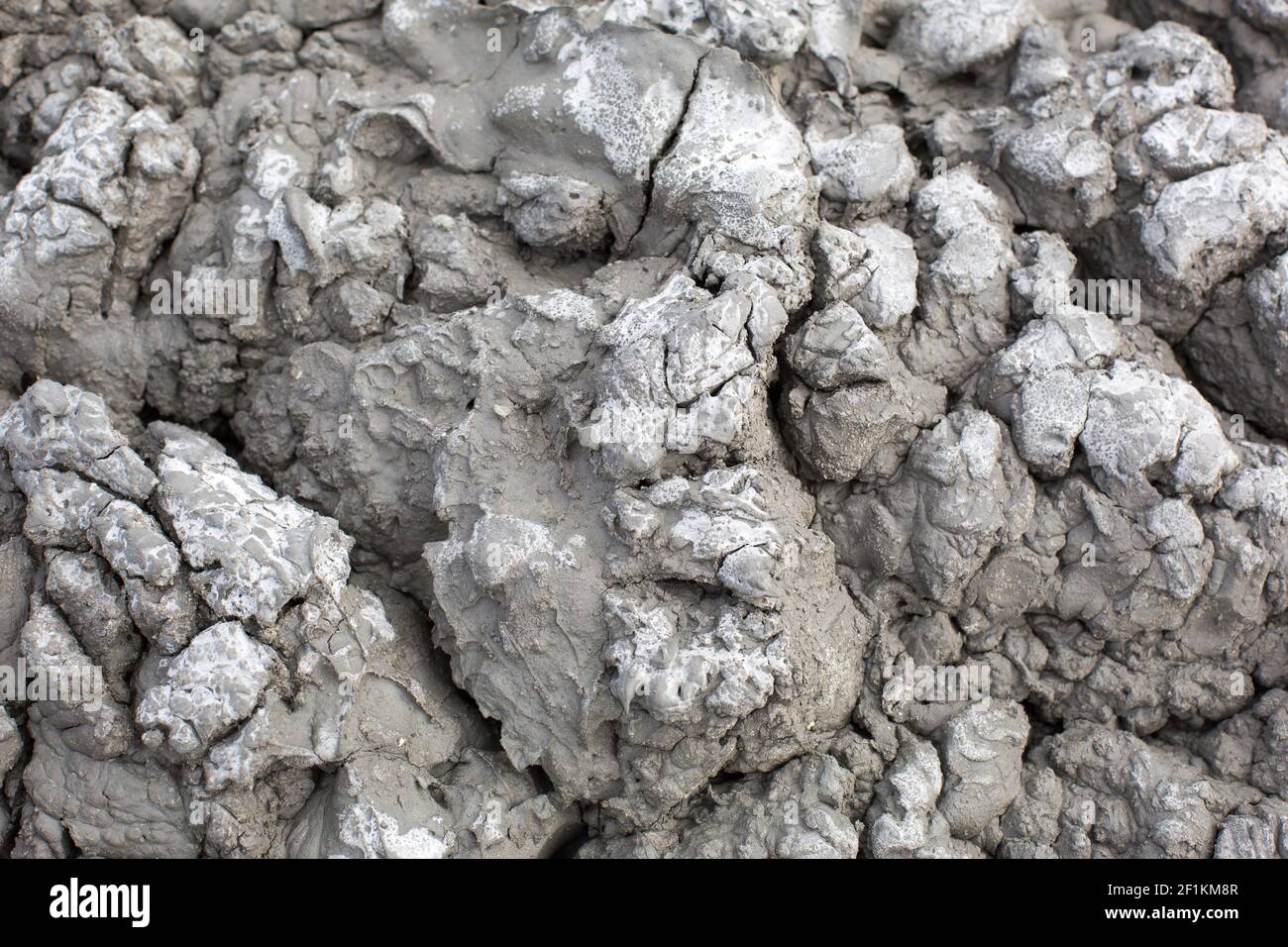 The texture of gray cracked earth, dried volcanic clay with cracks ...