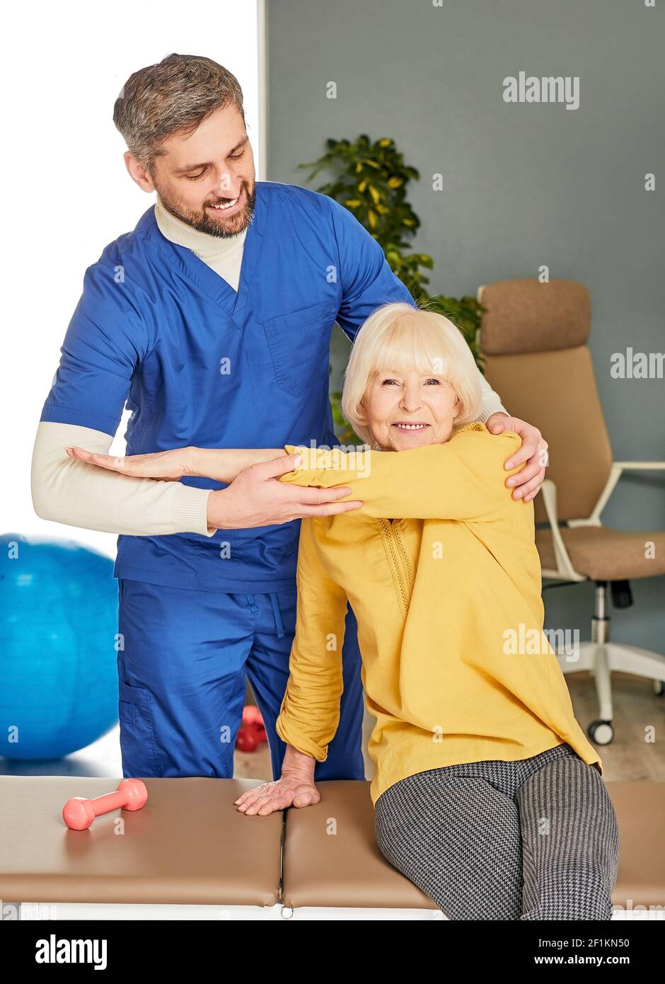 Senior patient while exercise treatment with his physiotherapist. Rehab ...
