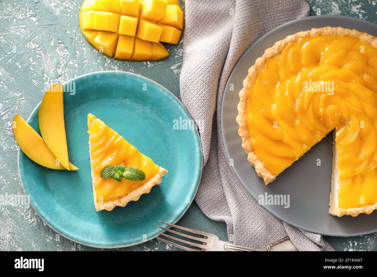 Plates with tasty mango pie on color background Stock Photo - Alamy