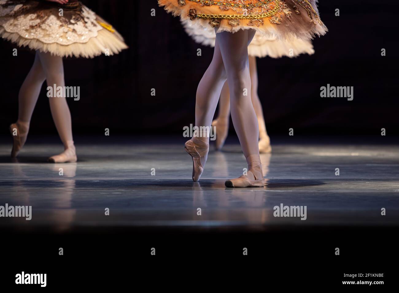 Closeup of ballerinas dancing on stage. Closeup of ballerinas legs ...