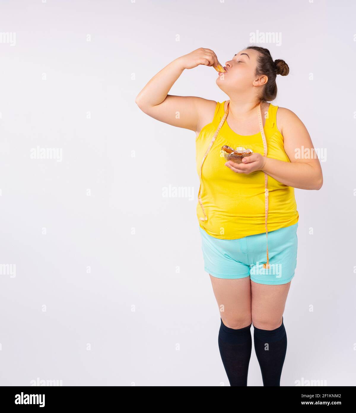 Beautiful size plus model, diet concept holding meter on neck, holding ...