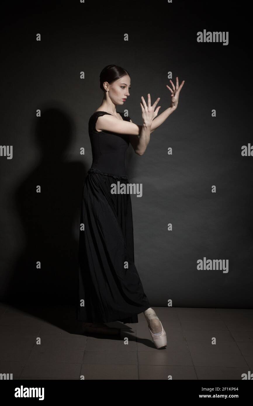 dramatic vintage portrait of a girl dancing ballerina in a black dress ...