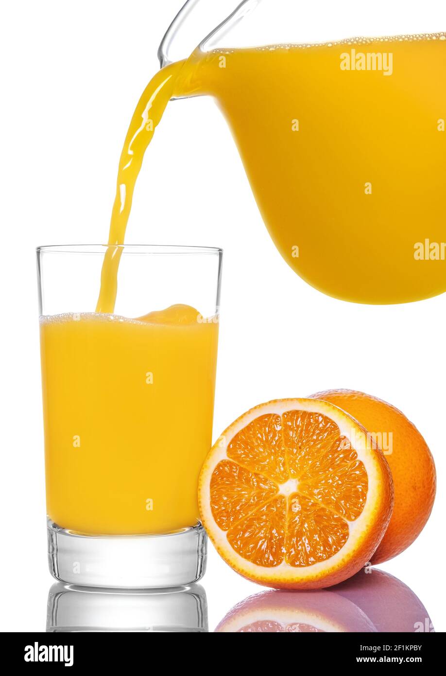 Orange juice pouring from pitcher into glass, isolated on white background Stock Photo - Alamy