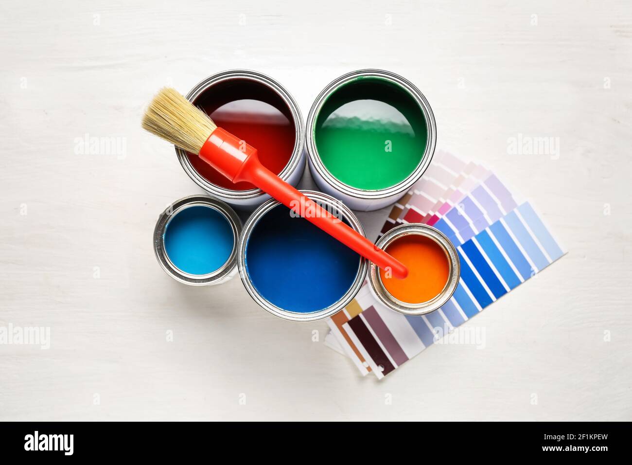 Cans of paints with palette samples and brush on white background Stock ...