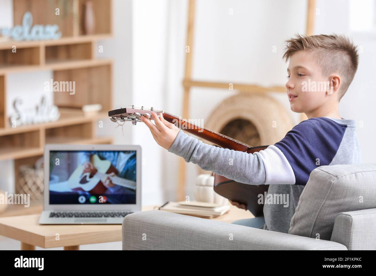 Little boy taking music lessons online at home Stock Photo - Alamy