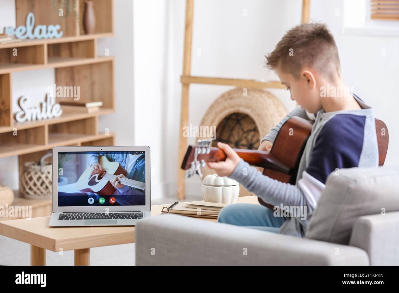 Little boy taking music lessons online at home Stock Photo - Alamy