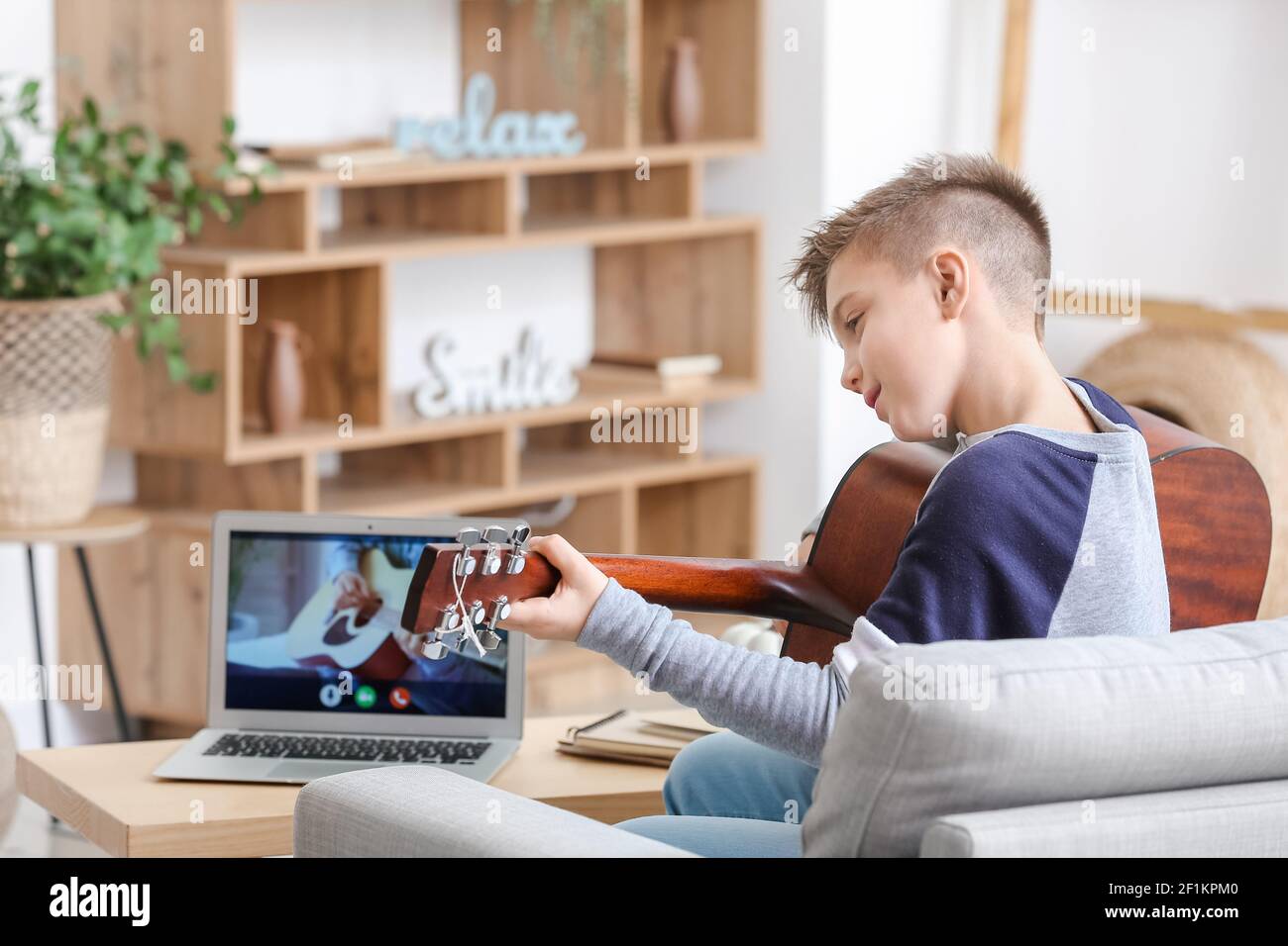Little boy taking music lessons online at home Stock Photo - Alamy