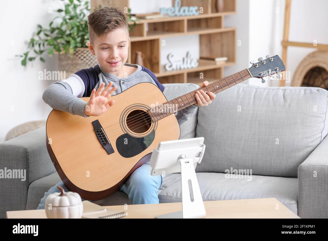 Little boy taking music lessons online at home Stock Photo - Alamy