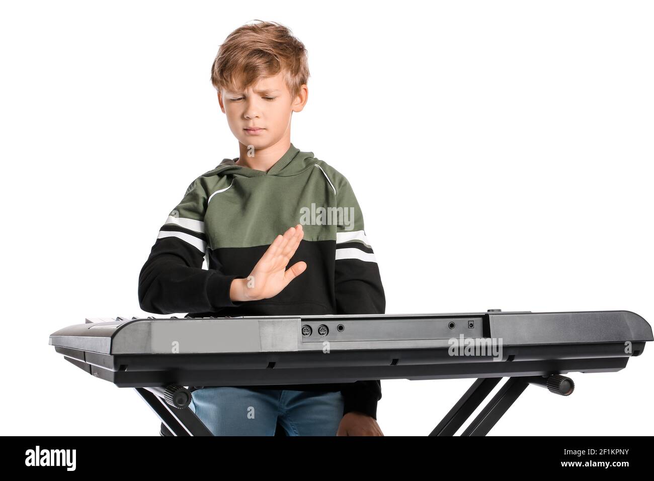 Little boy refusing to play synthesizer on white background Stock Photo ...