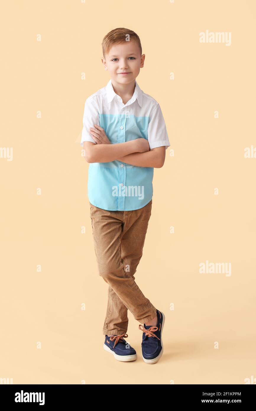Cute little boy with crossed arms on light background Stock Photo - Alamy