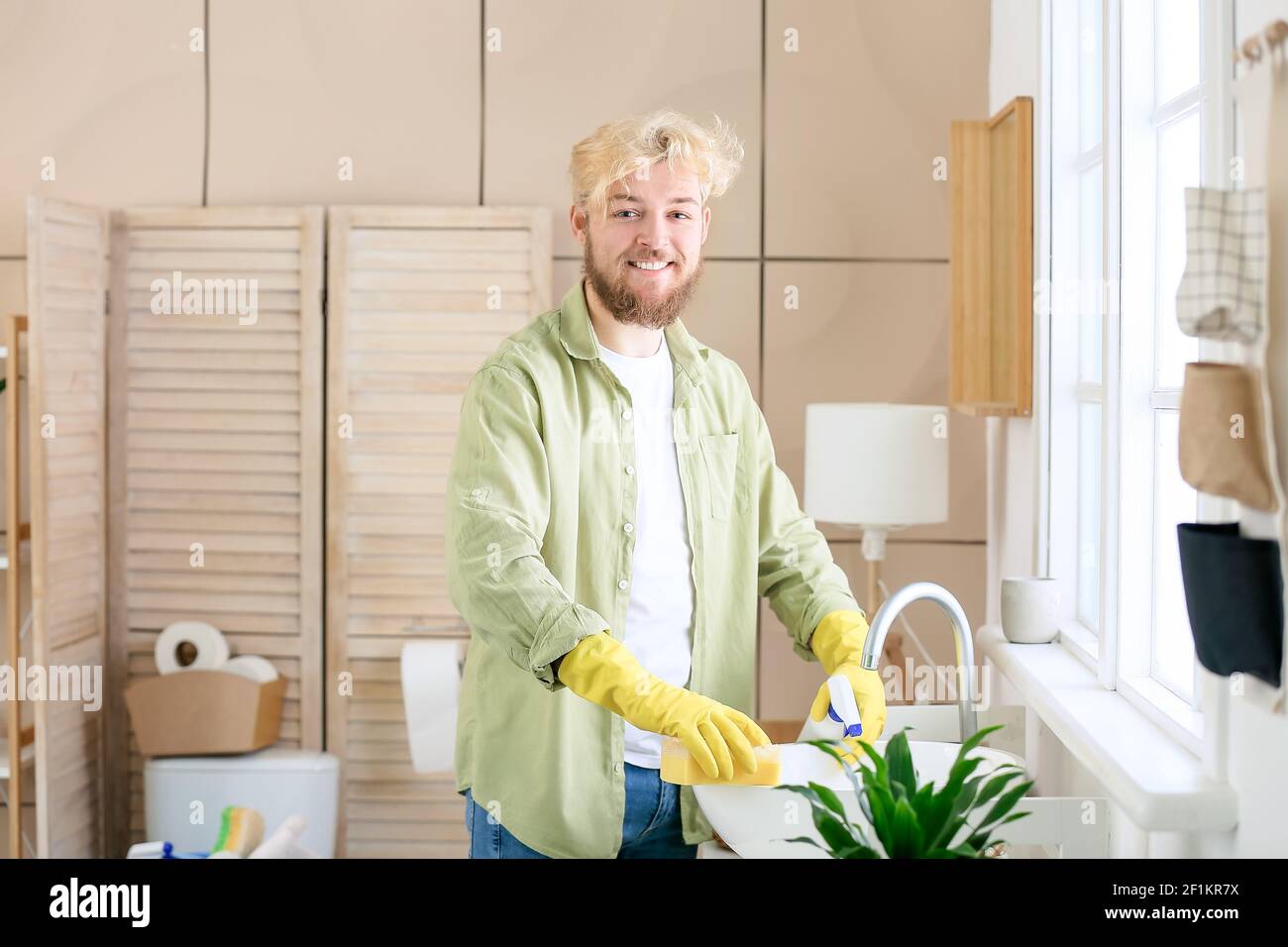 Young man cleaning his bathroom Stock Photo - Alamy