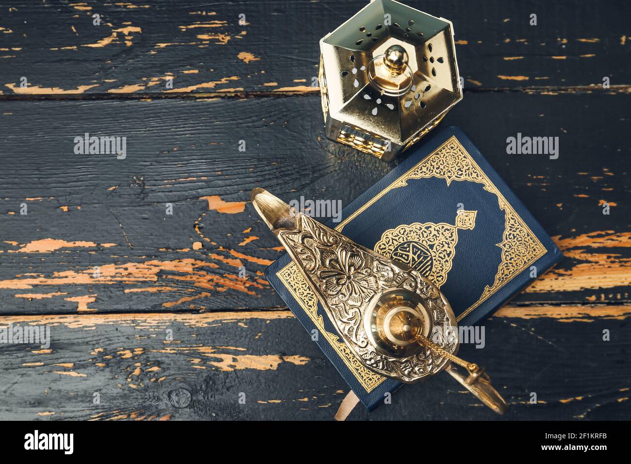 Aladdin lamp of wishes with Koran and Muslim lamp on dark wooden ...