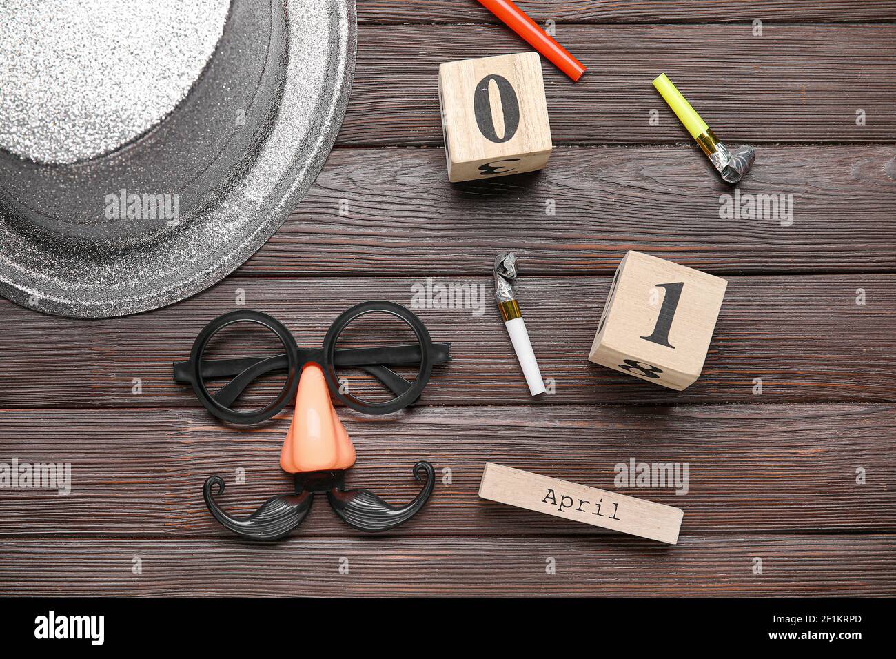 Party decor and calendar with date of April Fools Day on wooden ...