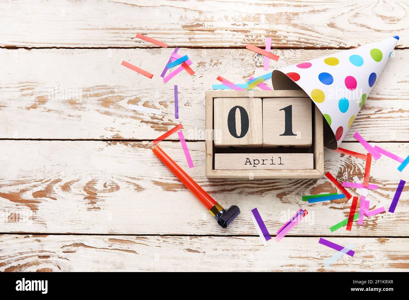 Party decor and calendar with date of April Fools Day on white wooden ...