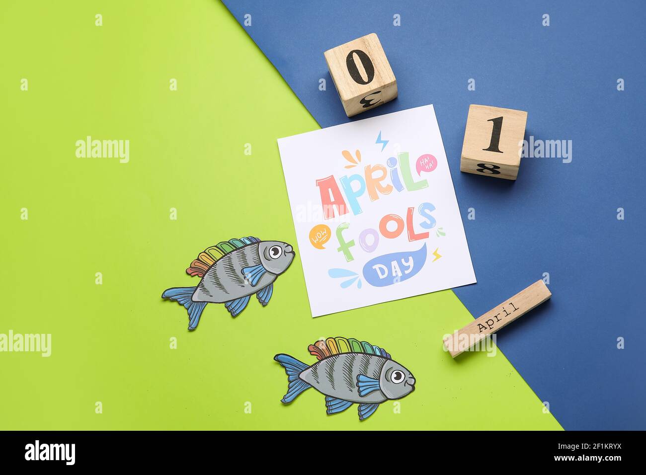 Paper fishes and calendar with date of April Fools Day on color ...