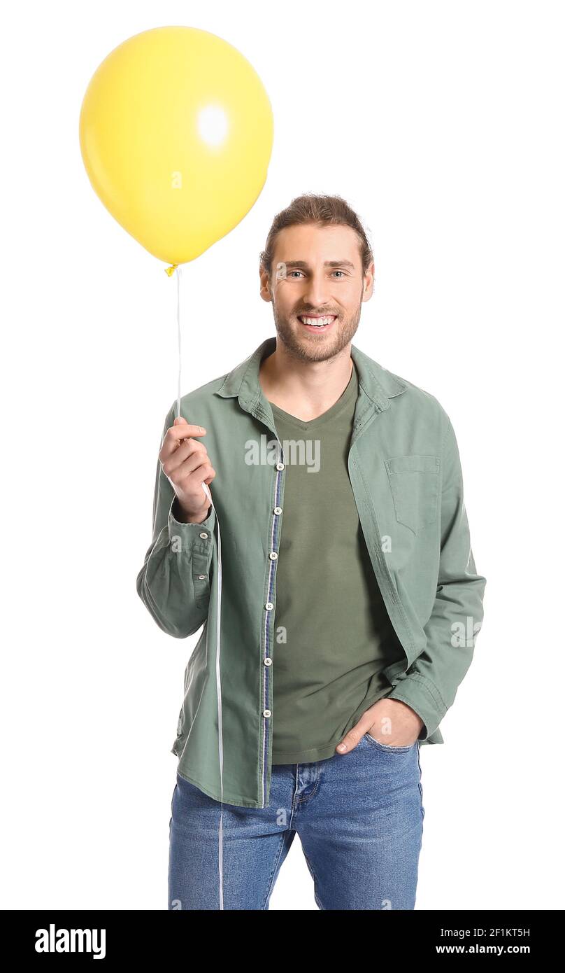 Handsome young man with balloon on white background Stock Photo - Alamy