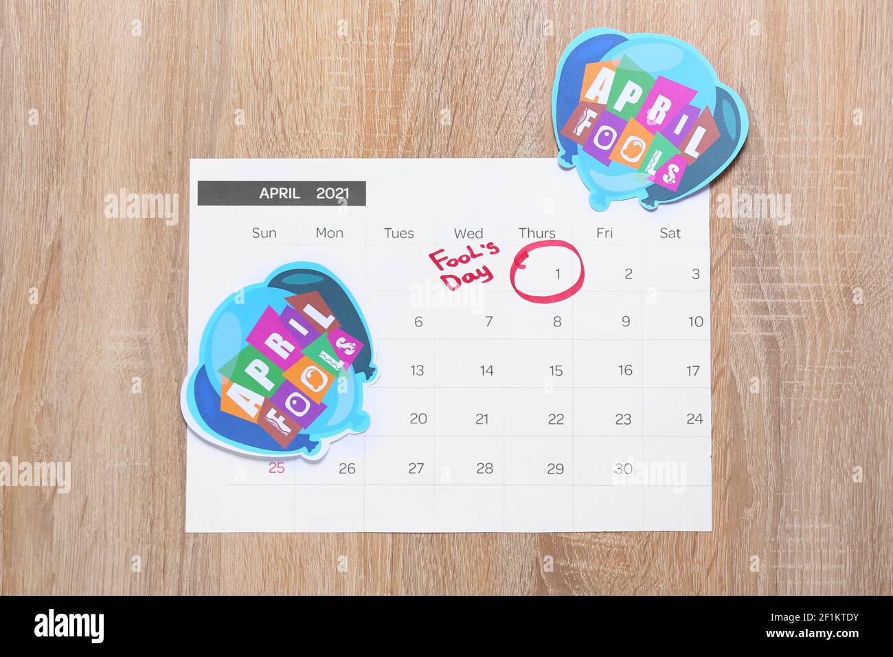 Calendar with marked date of April Fool's Day on wooden background ...