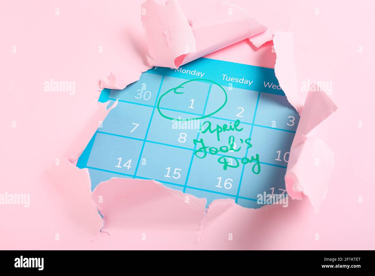Calendar with marked date of April Fool's Day visible through hole in ...